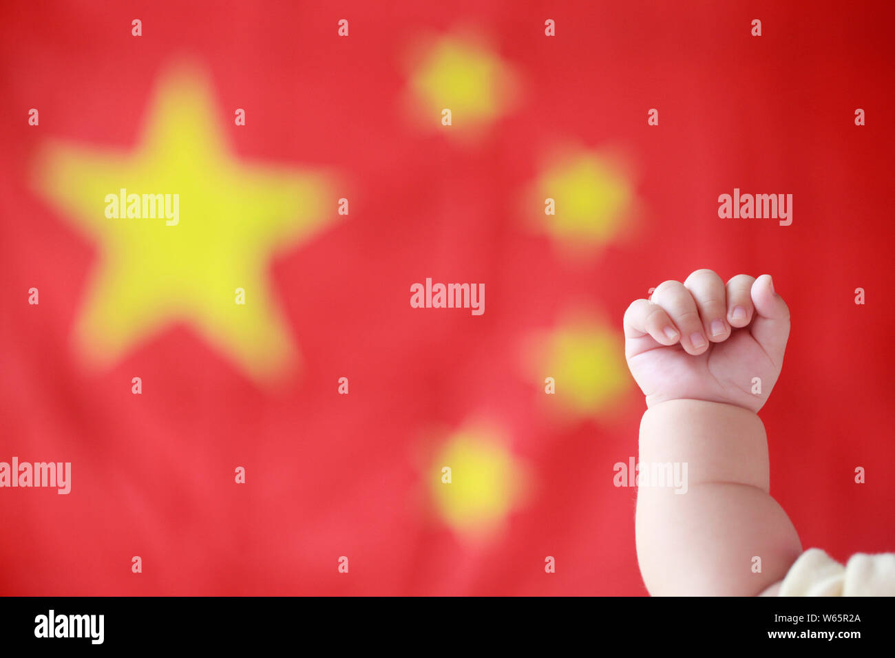 --FILE--A newborn baby is pictured in front of the national flag of the ...