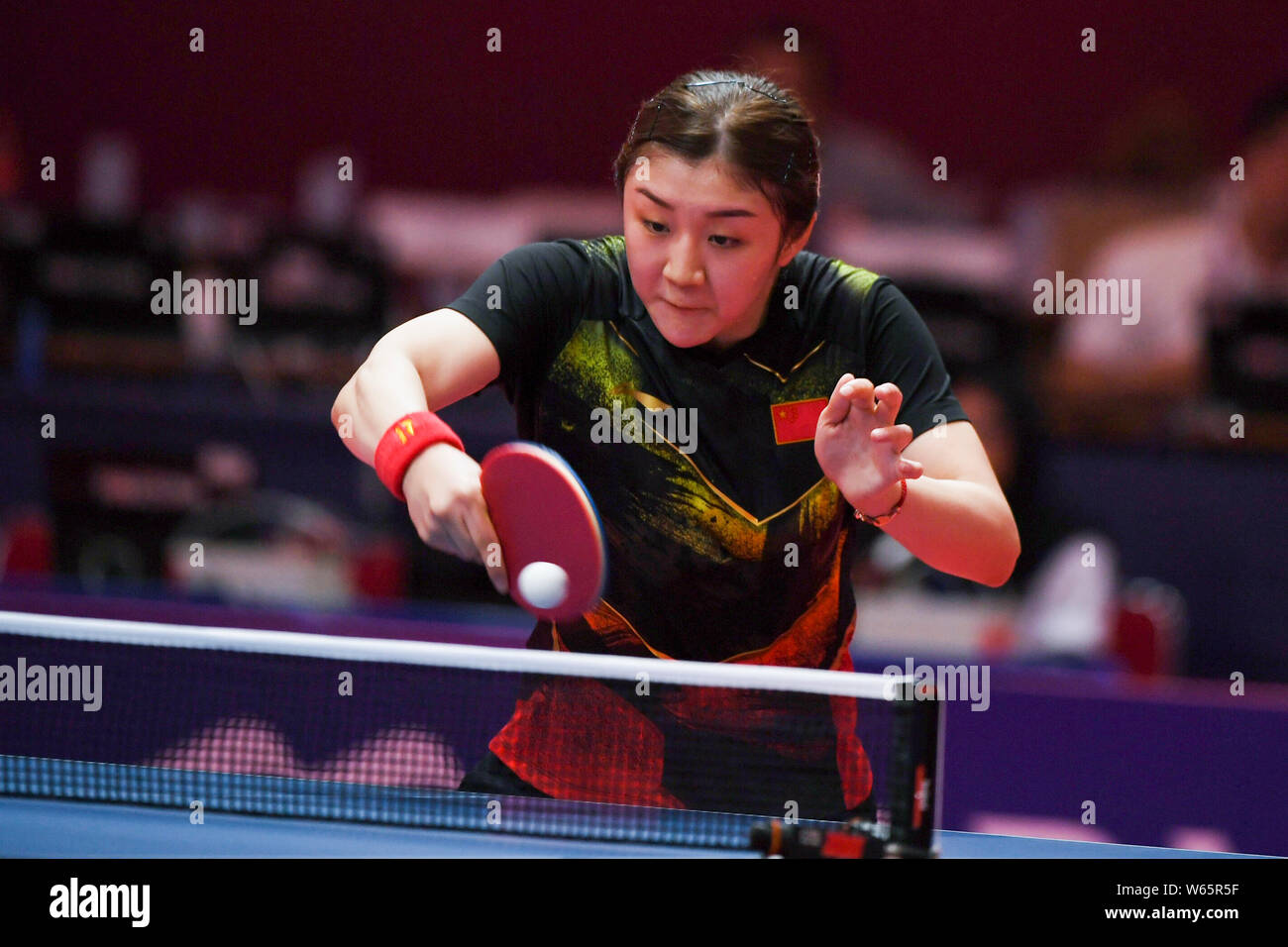 Chen Meng of China returns a shot to Cha Hyo-sim of North Korea in the ...