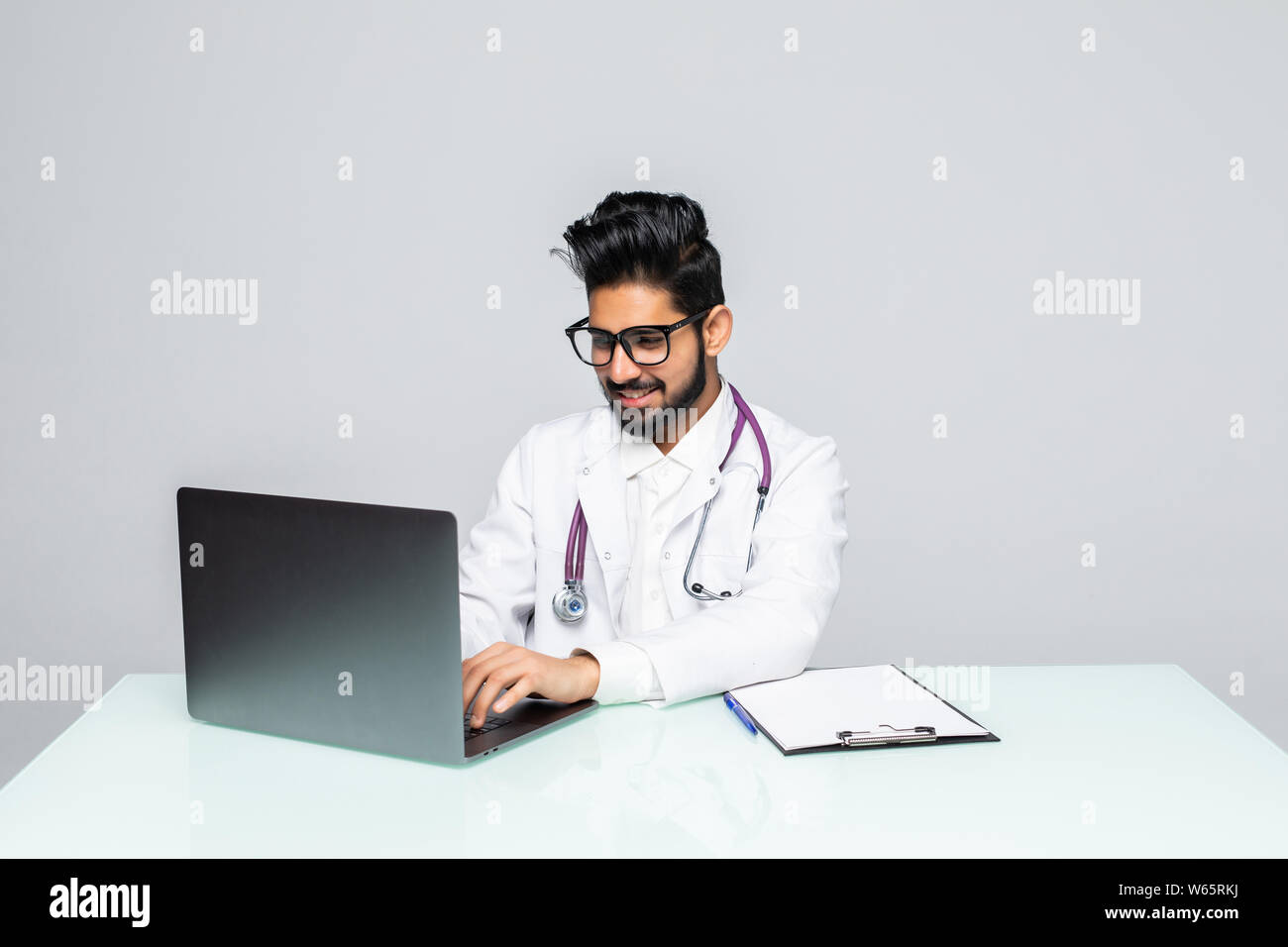 Indian male doctor looking laptop hi-res stock photography and images ...