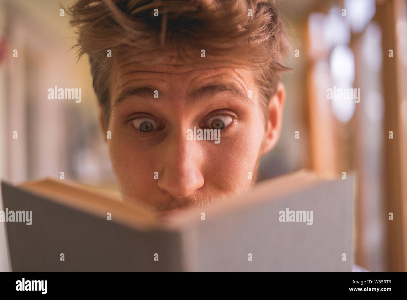 close up view of man's eyes looking in the book, careful reading Stock ...