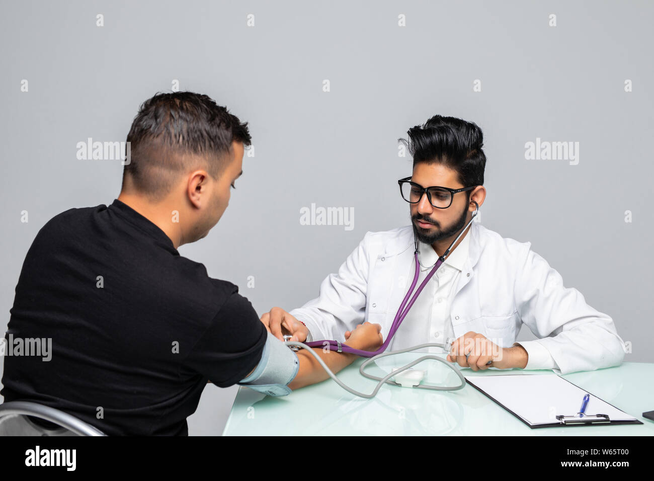 Doctor Holding Dial While Measuring Man's Blood Pressure Stock Photo ...