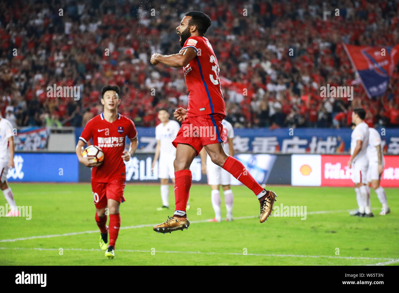 Brazilian football player Luiz Fernandinho, top, of Chongqing SWM ...