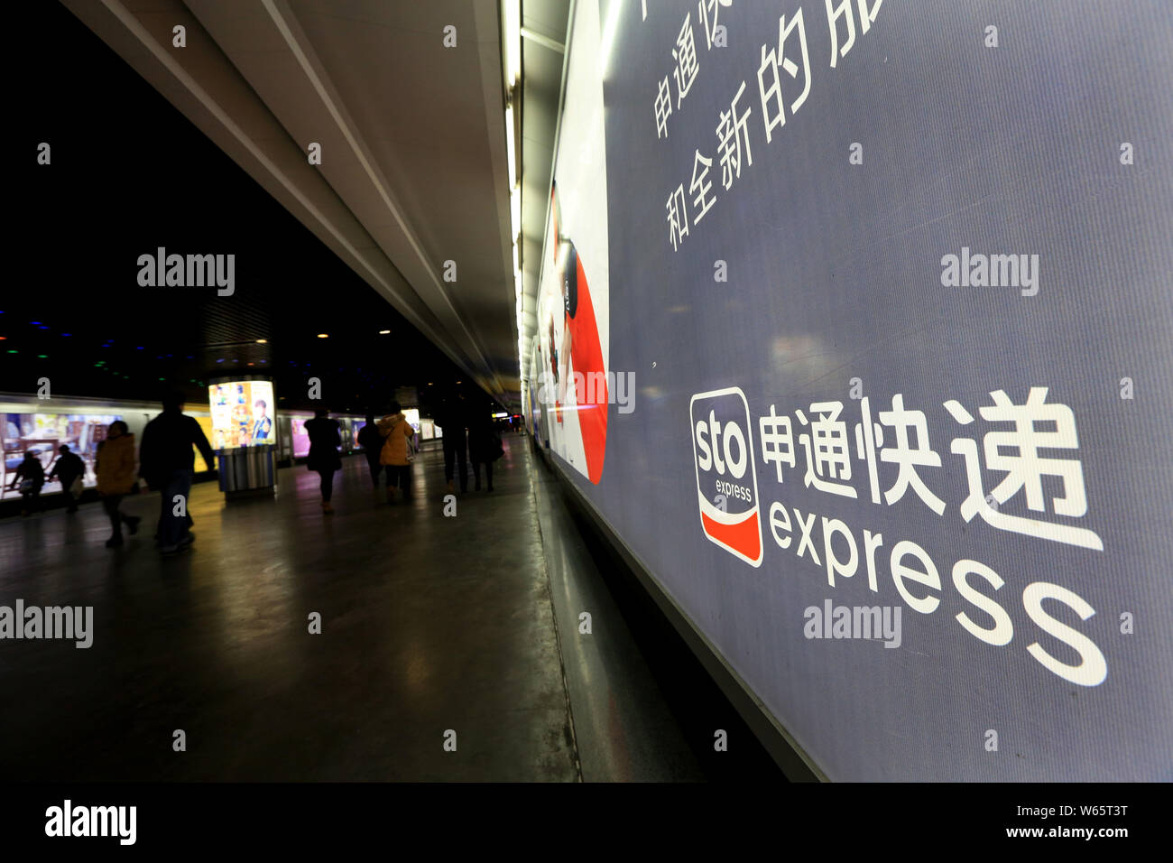 --FILE--Chinese pedestrians walk past an advertisement of Chinese ...