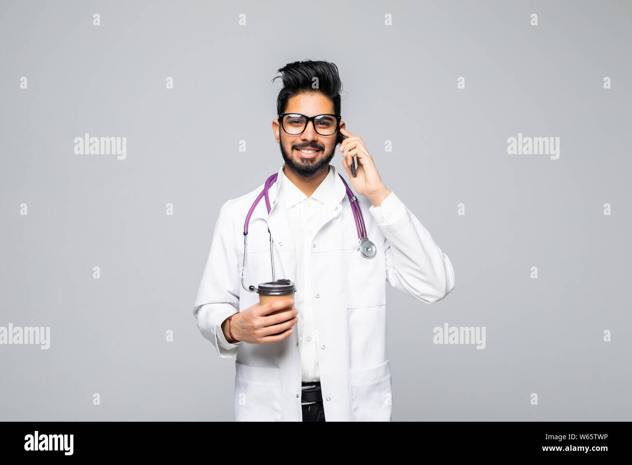 Photo of happy doctor talking on phone and drinking coffee Stock Photo ...