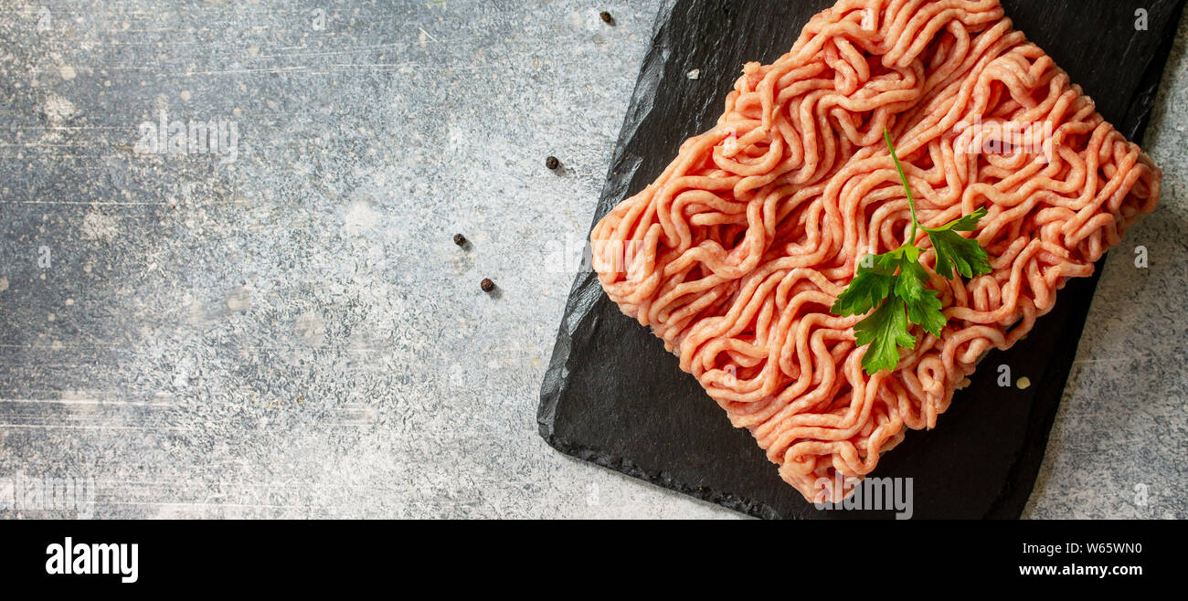 Fresh Raw mince. Ground Minced beef on stone slate blackboard. Top view ...