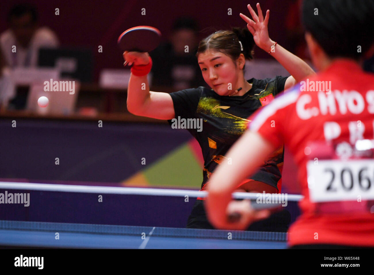 Chen Meng of China returns a shot to Cha Hyo-sim of North Korea in the ...