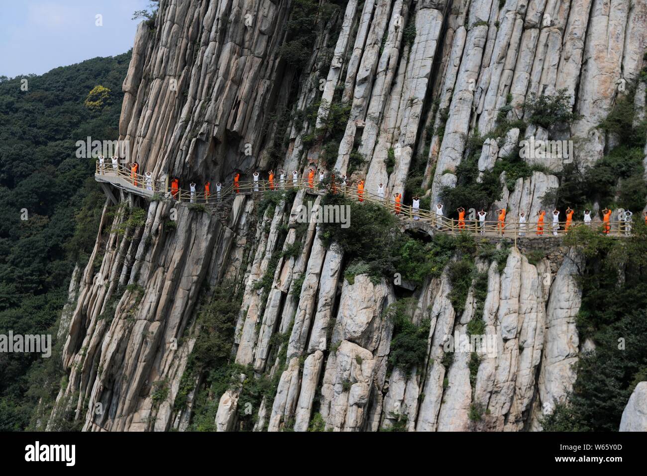 In this aerial view, Yoga lovers practice yoga and Shaolin students ...