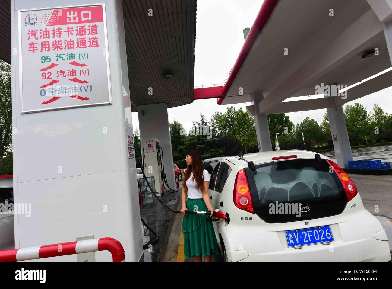 --FILE--Vehicles are being refueled at a gas station of China Petroleum ...