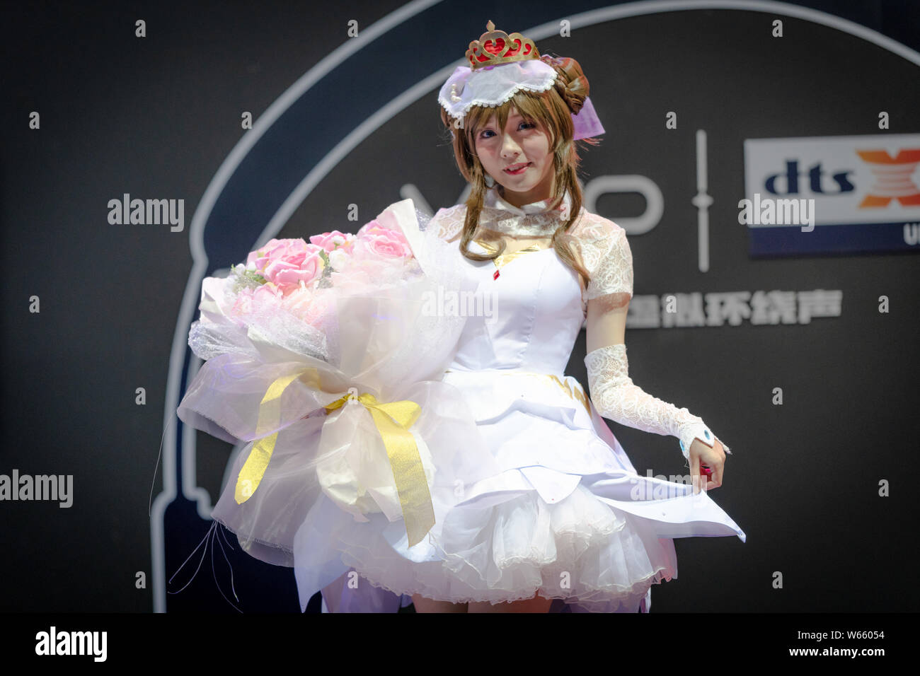 A Chinese showgirl, dressed in cosplay costume, poses during the 16th ...
