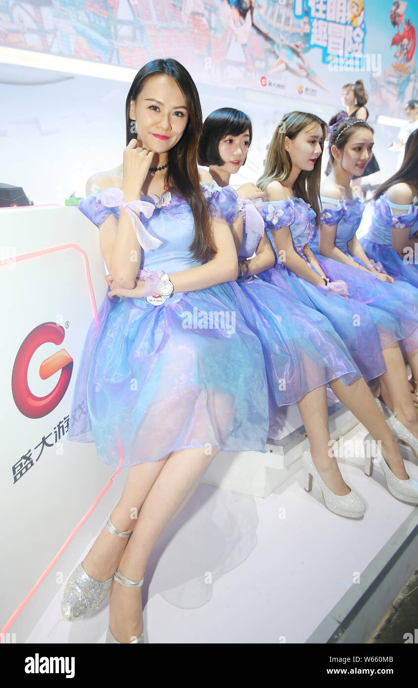 Chinese showgirls pose at the stand of Shanda Games during the 16th China Digital Entertainment ...