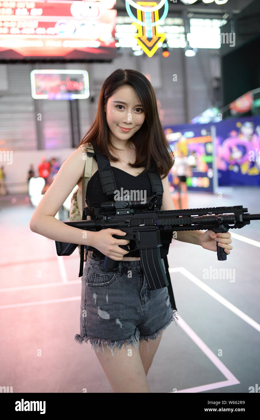 A Chinese showgirl, dressed in cosplay costume, poses during the 16th ...