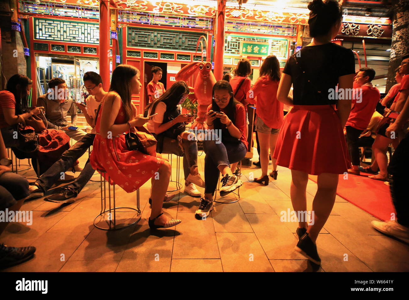 --FILE--Customers wait for tables at a crayfish restaurant on the ...