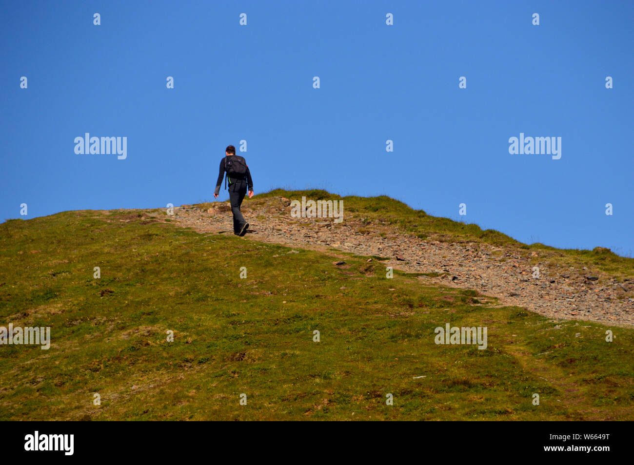 Lone Man Walking on the Ridge Path to the Summit of the Wainwright ...