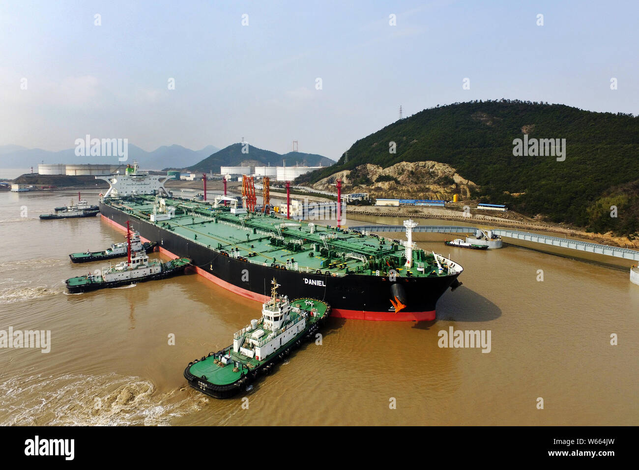 --FILE--Tugboats dock the oil tanker "Daniel" carrying crude oil ...