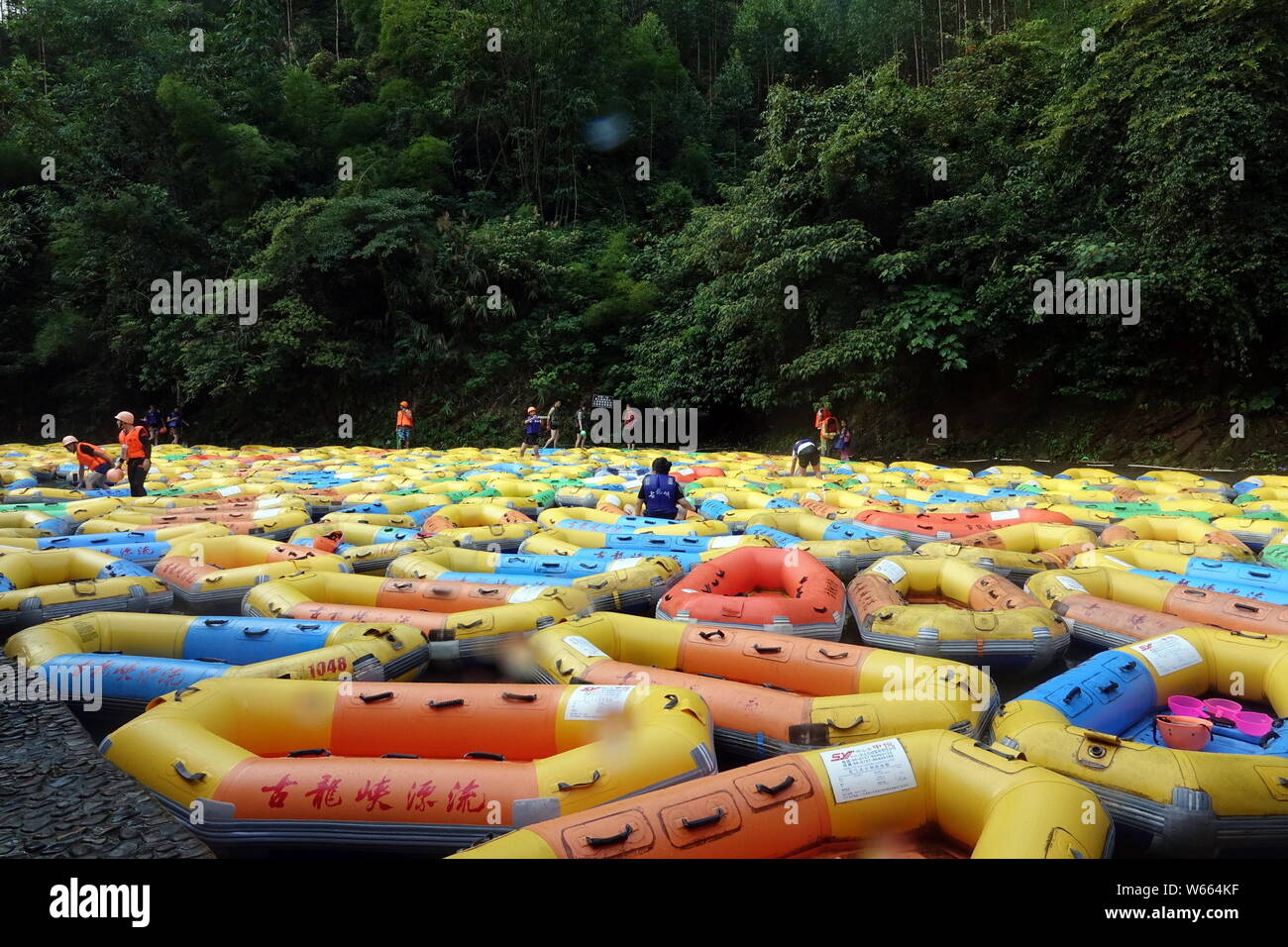 A crowd of tourists sitting on inflatable rafts jam Gulong Valley as ...