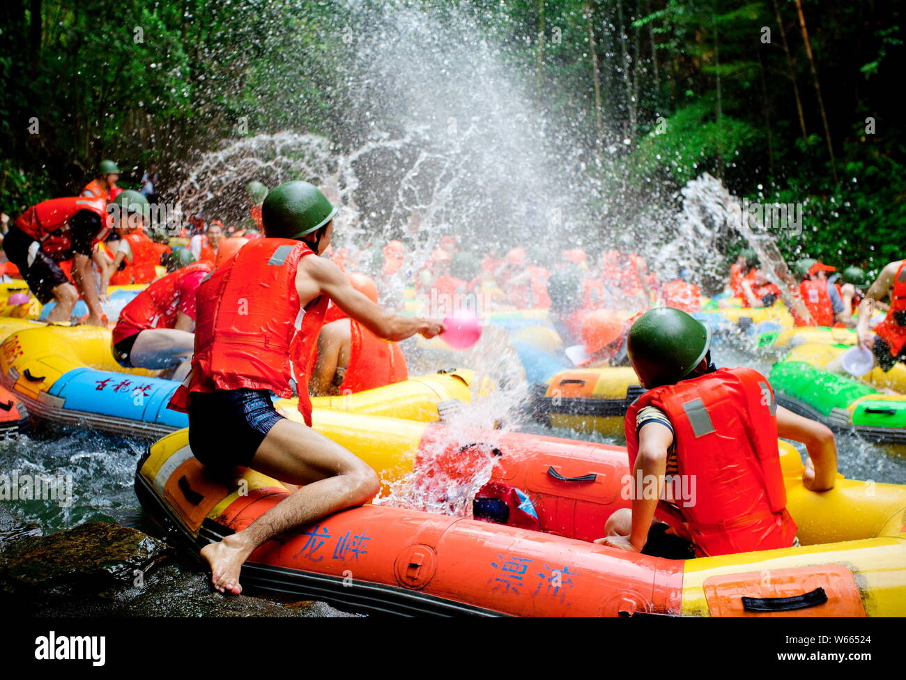 A crowd of tourists sitting on inflatable rafts jam Gulong Valley as ...