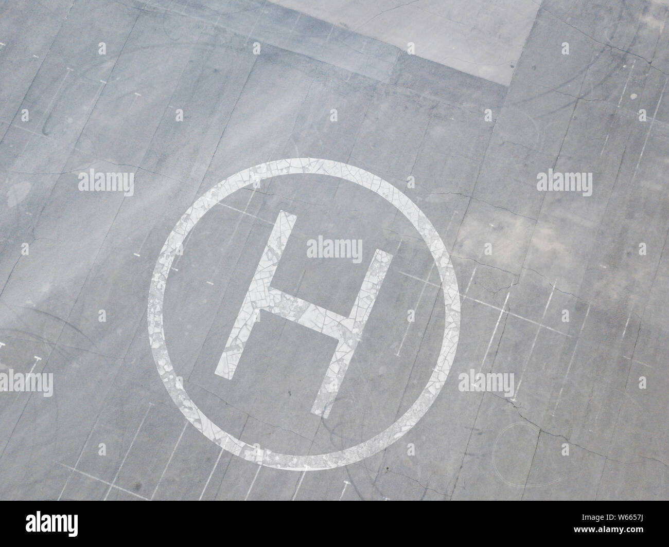 helicopter helipad on the asphalt surface with letter "H" view from ...