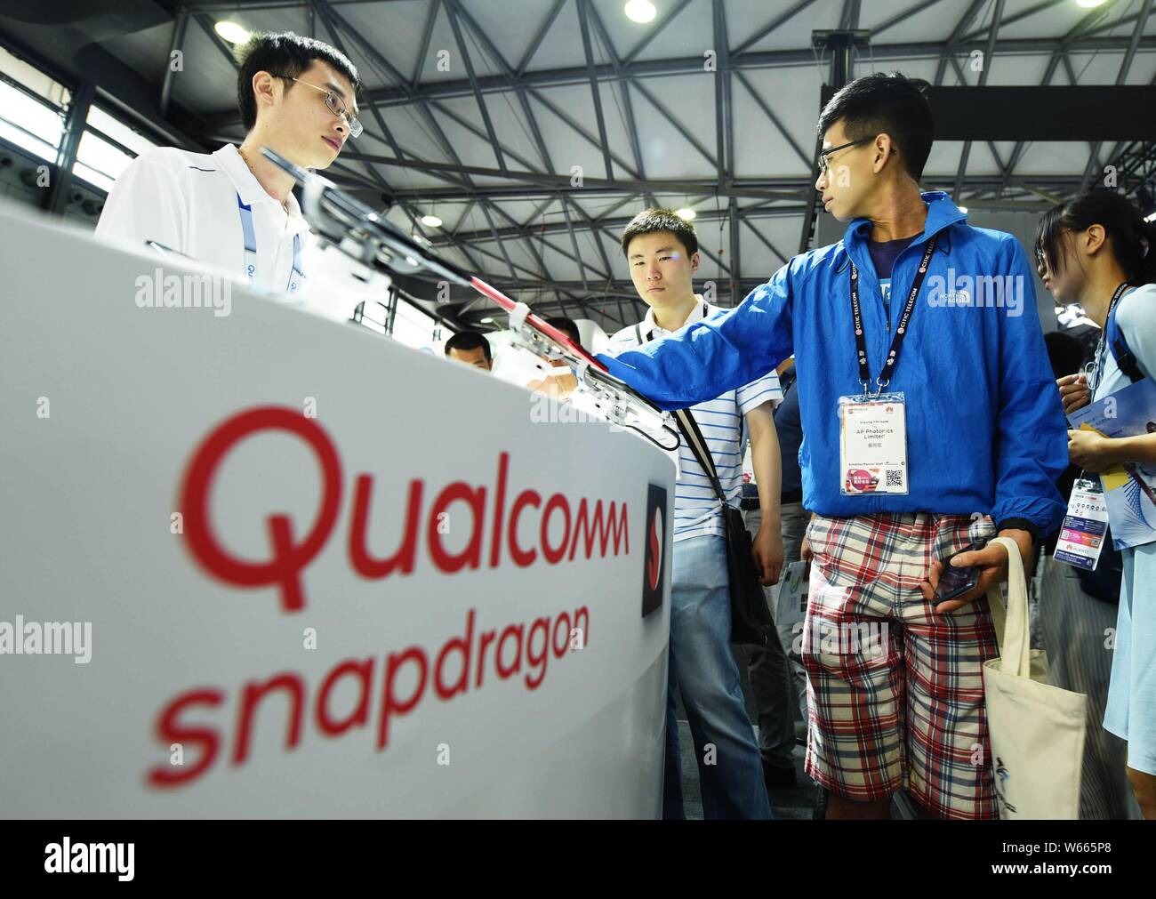--FILE--People visit the stand of Qualcomm during the 2018 Mobile World ...