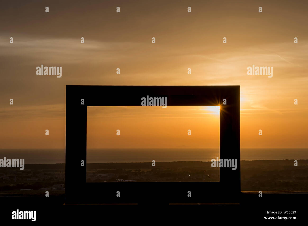 Beautiful sunset over the sea framed by a large black frame Stock Photo ...
