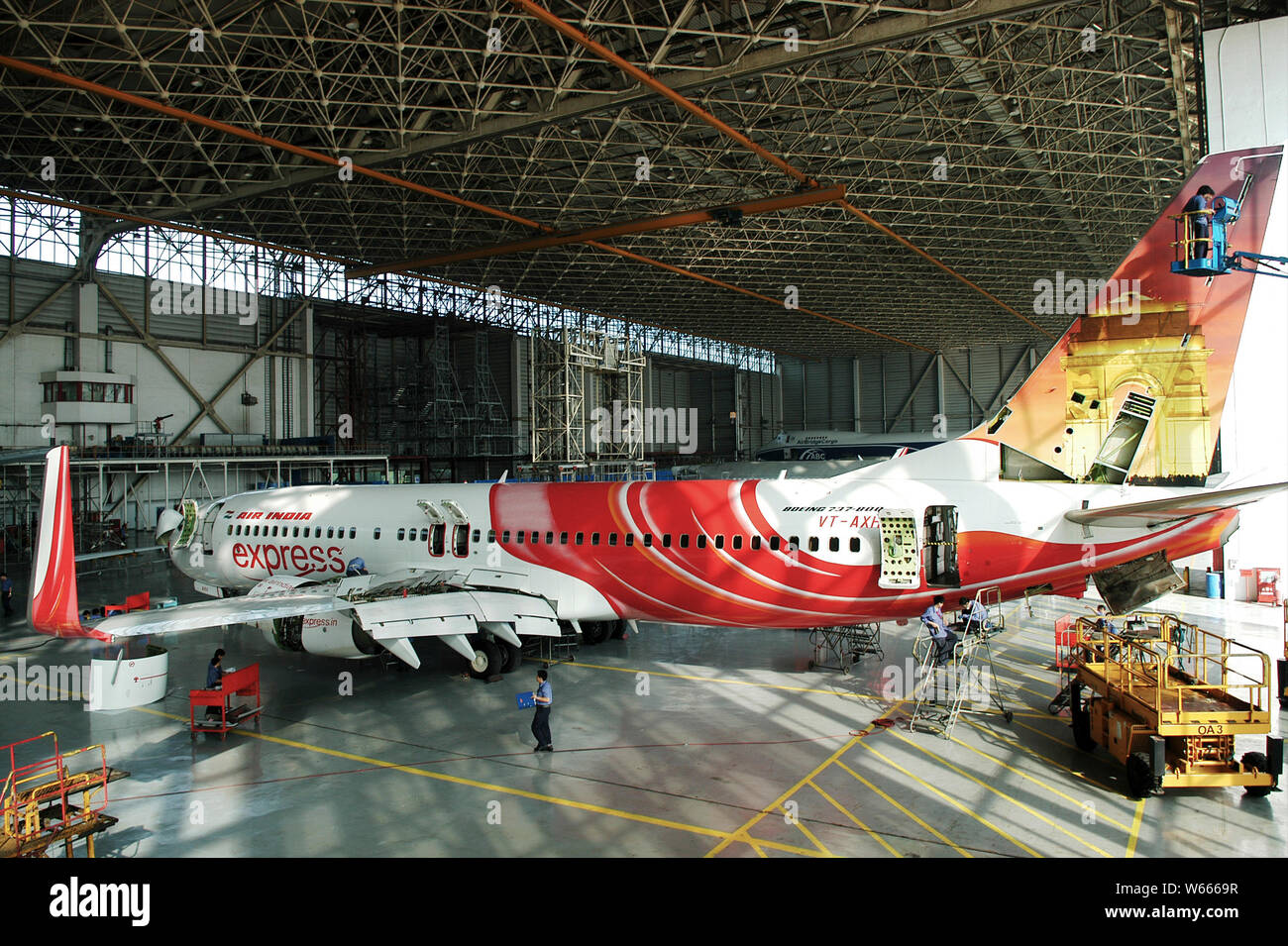 --FILE--A Boeing 737-800 jet plane of Air India is being painted at a ...