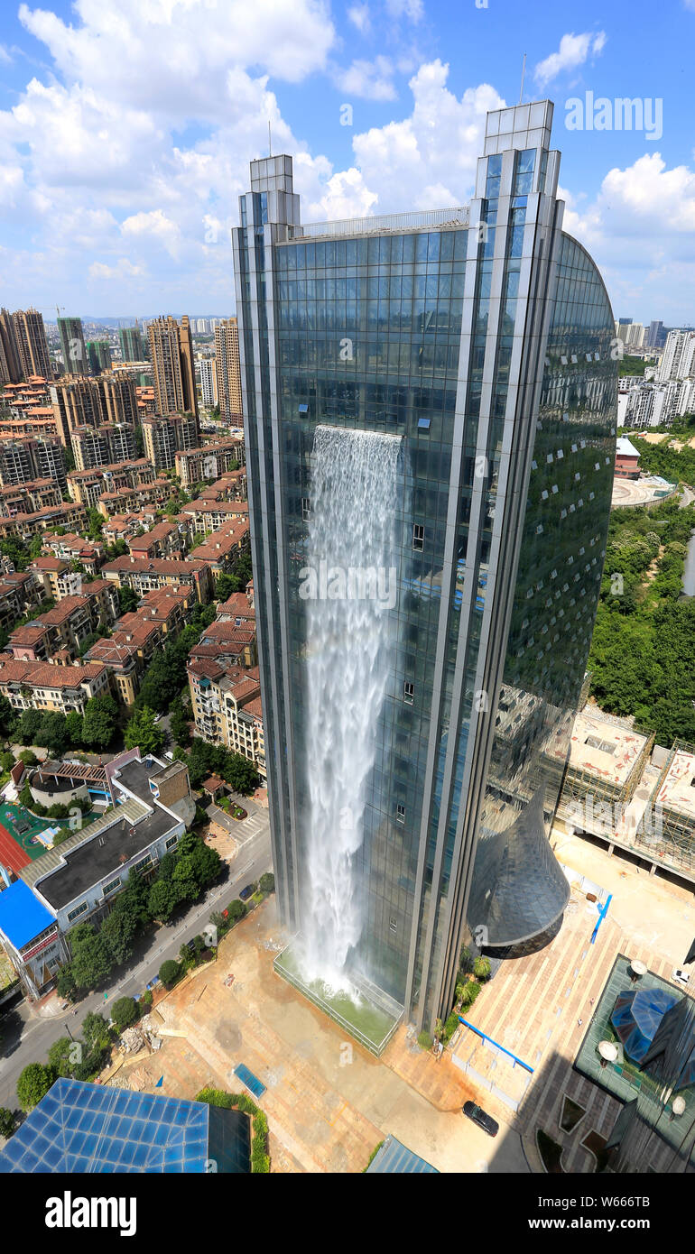 View of an artificial waterfall on the exterior of a 121-meter-tall ...