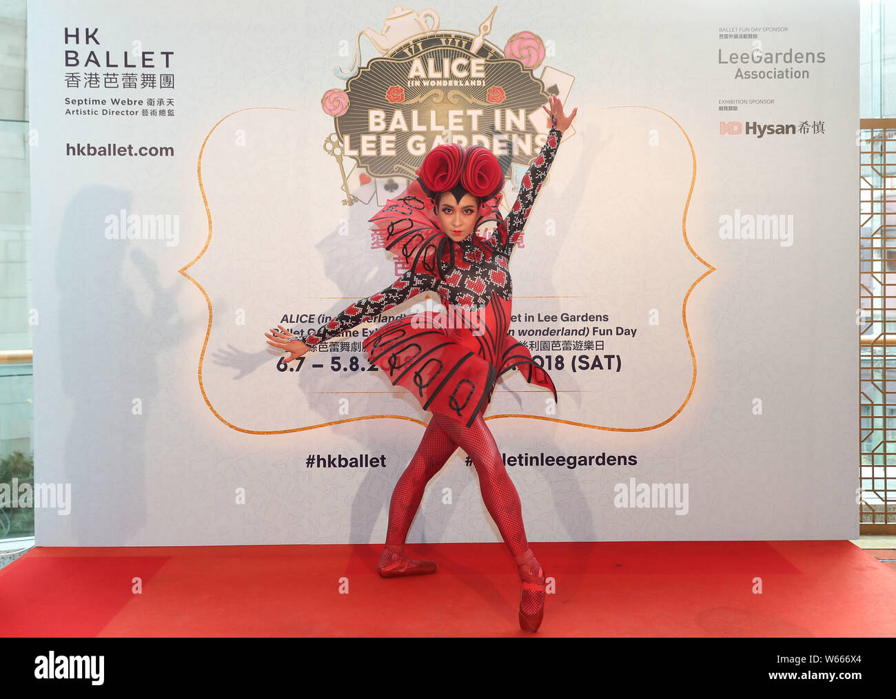 A ballet dancer poses at a city parade event for the Asia debut of ...