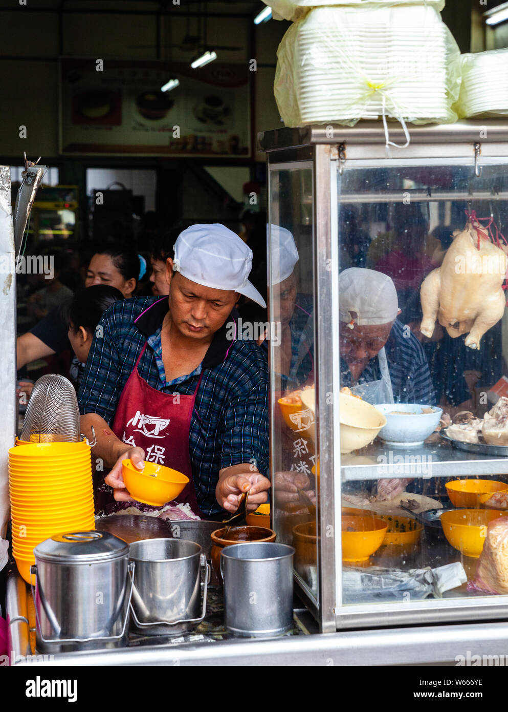 IPOH, MALAYSIA - DECEMBER 11: Man serves up chicken soup for clients on ...