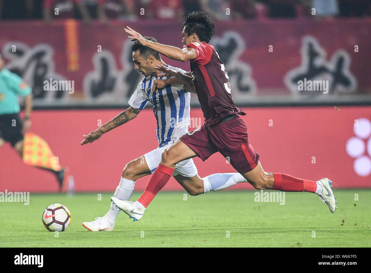 Israeli football player Eran Zahavi, left, of Guangzhou R&F passes the ...