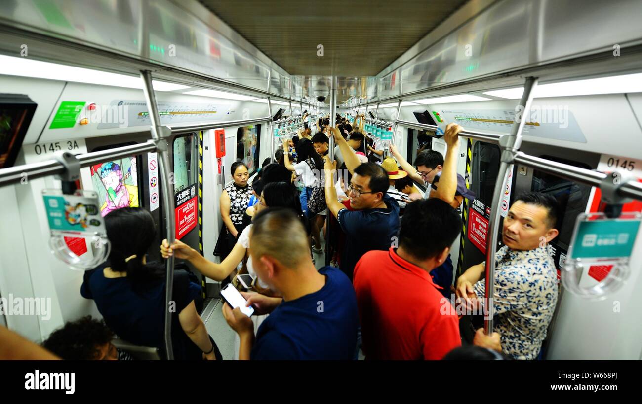 Passengers take a subway train on the Metro Line 6 spraying a nano ...