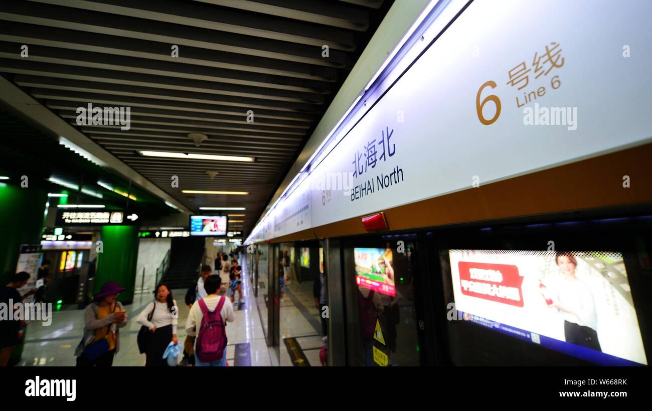 Passengers wait for a subway train on the Metro Line 6 spraying a nano ...