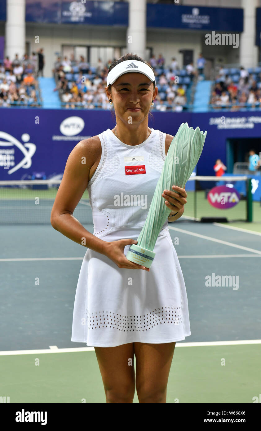 Wang Qiang of China poses with her trophy after defeating Zheng Saisai of China in their women's ...