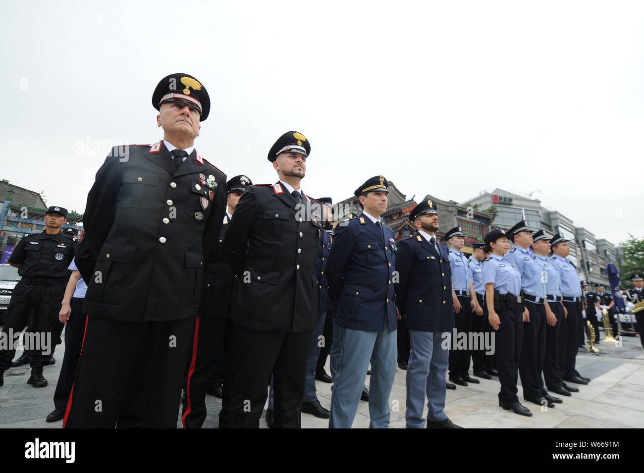Police officers from China and Italy attend a ceremony held to ...