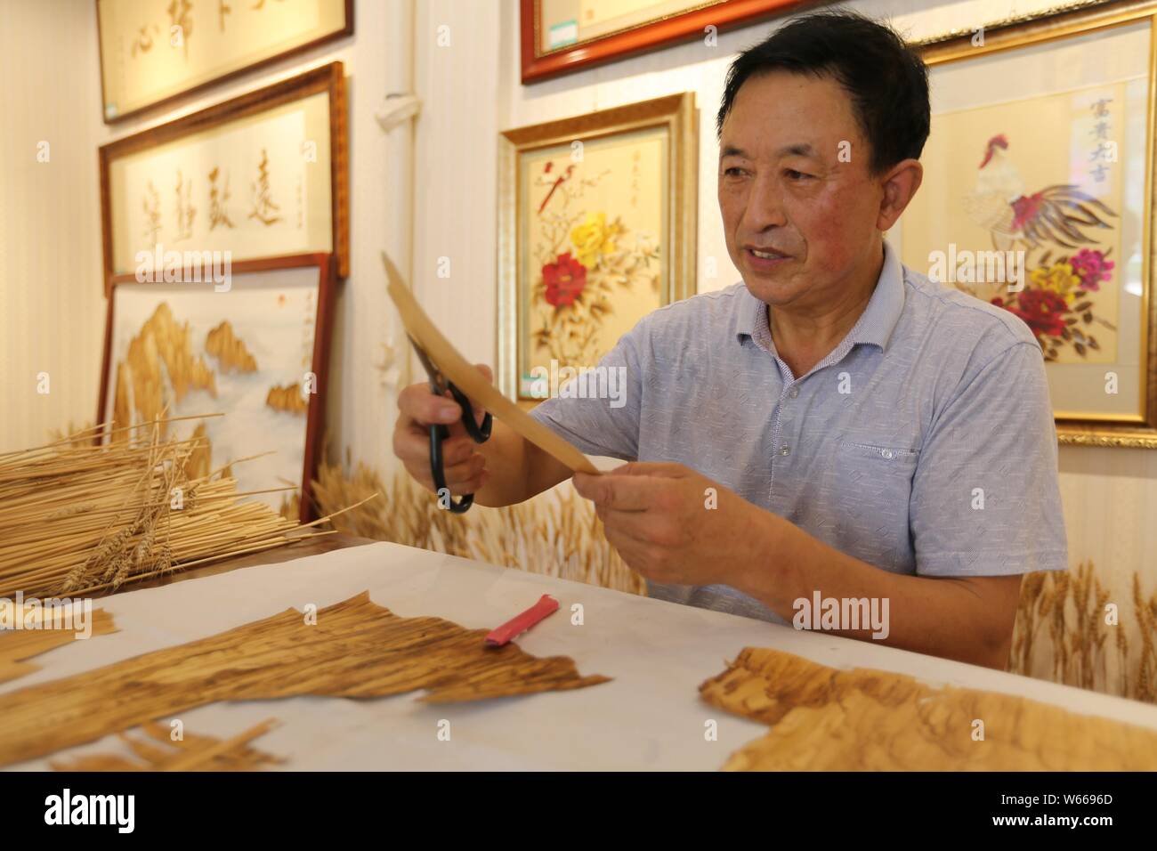Chinese craftsman Ding Xisen creates a wheat straw painting at his ...