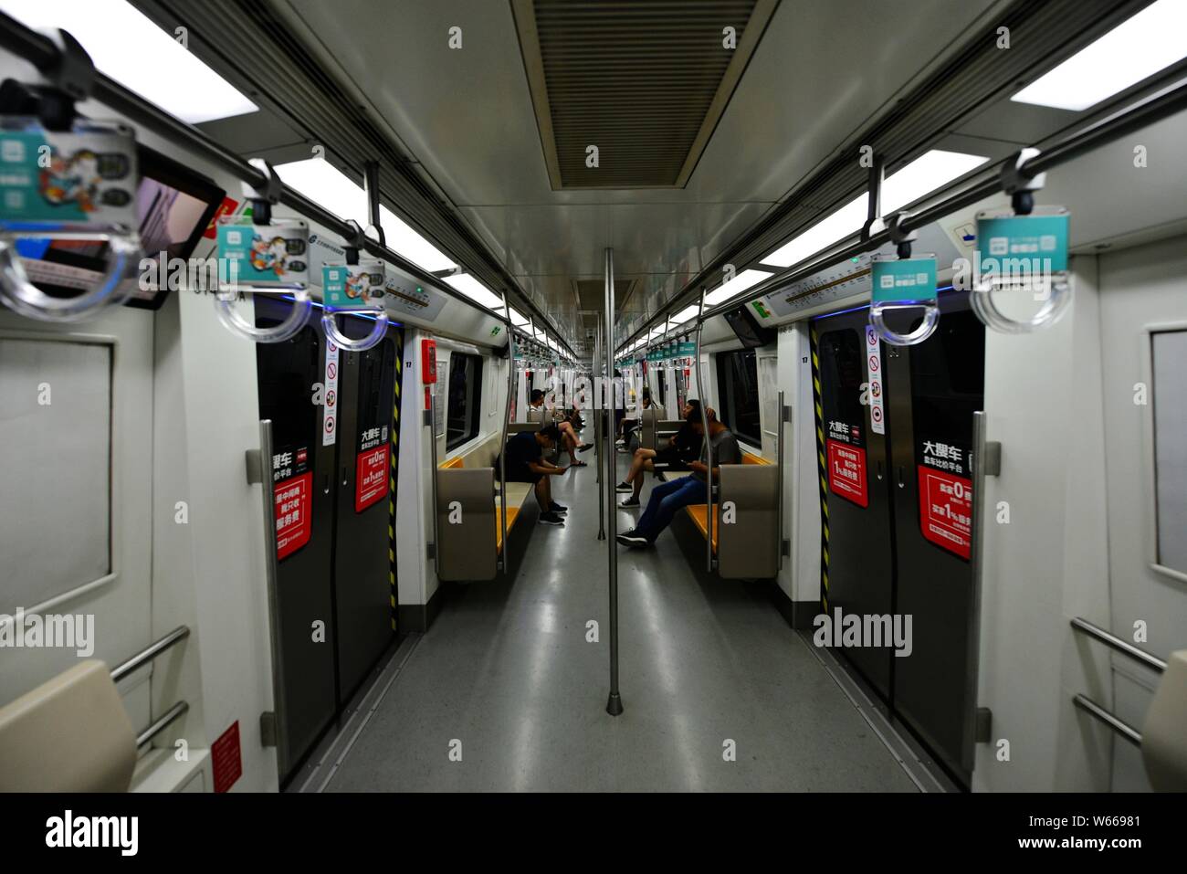 Passengers take a subway train on the Metro Line 6 spraying a nano ...