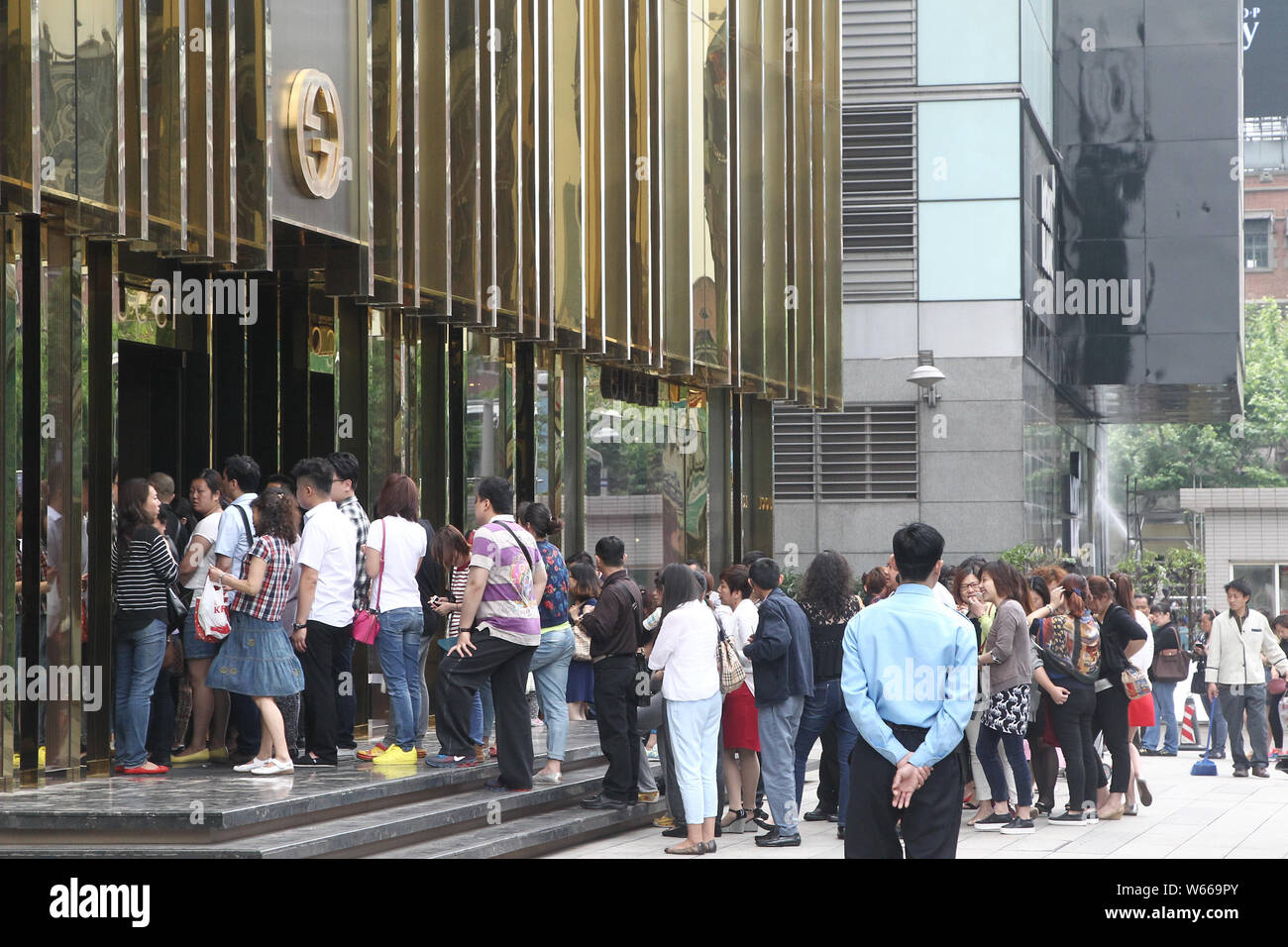 --FILE--Customers queue up outside a Gucci boutique in Shanghai, China ...