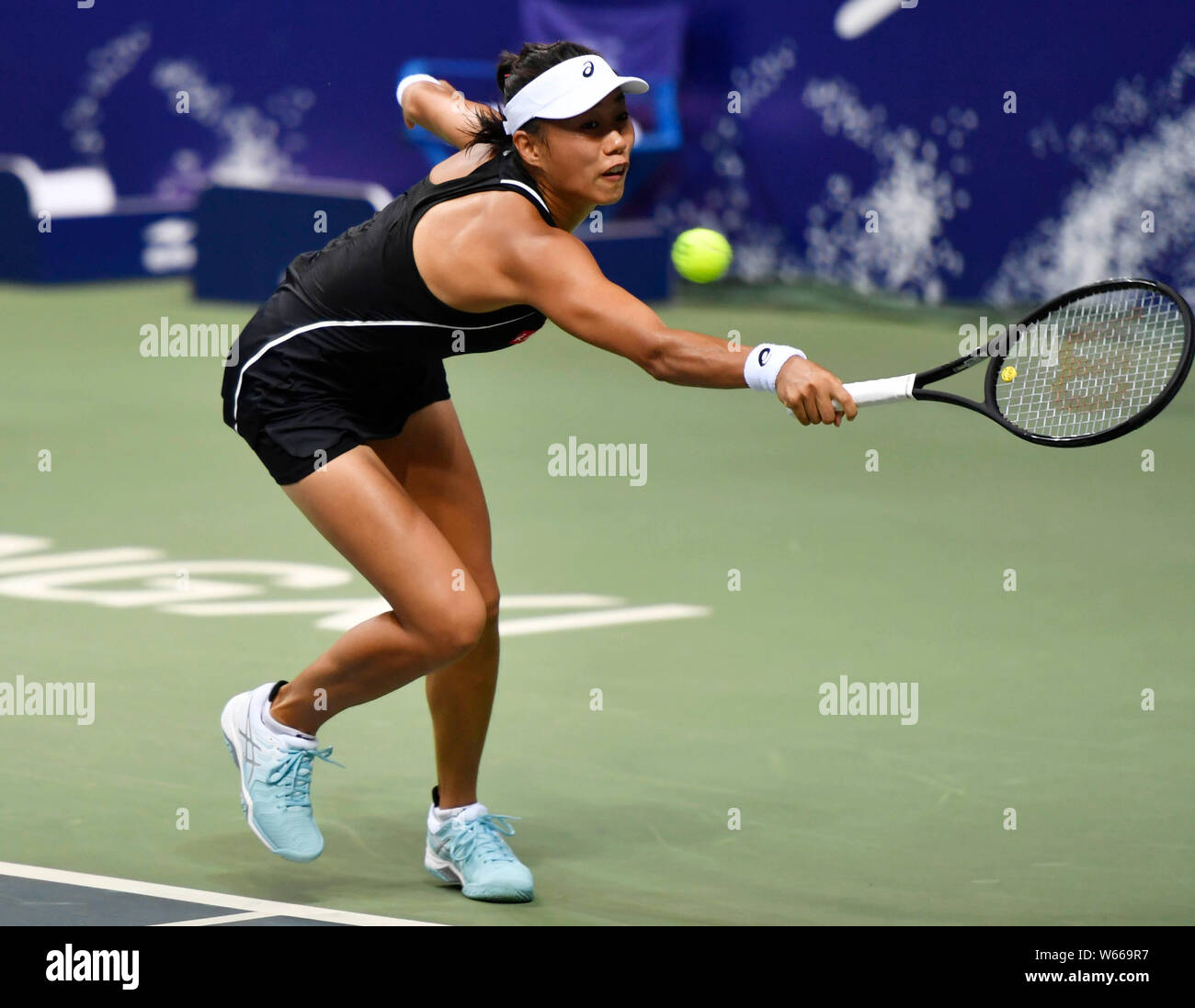 Zhang Shuai of China returns a shot to Sabine Lisicki of Germany in ...
