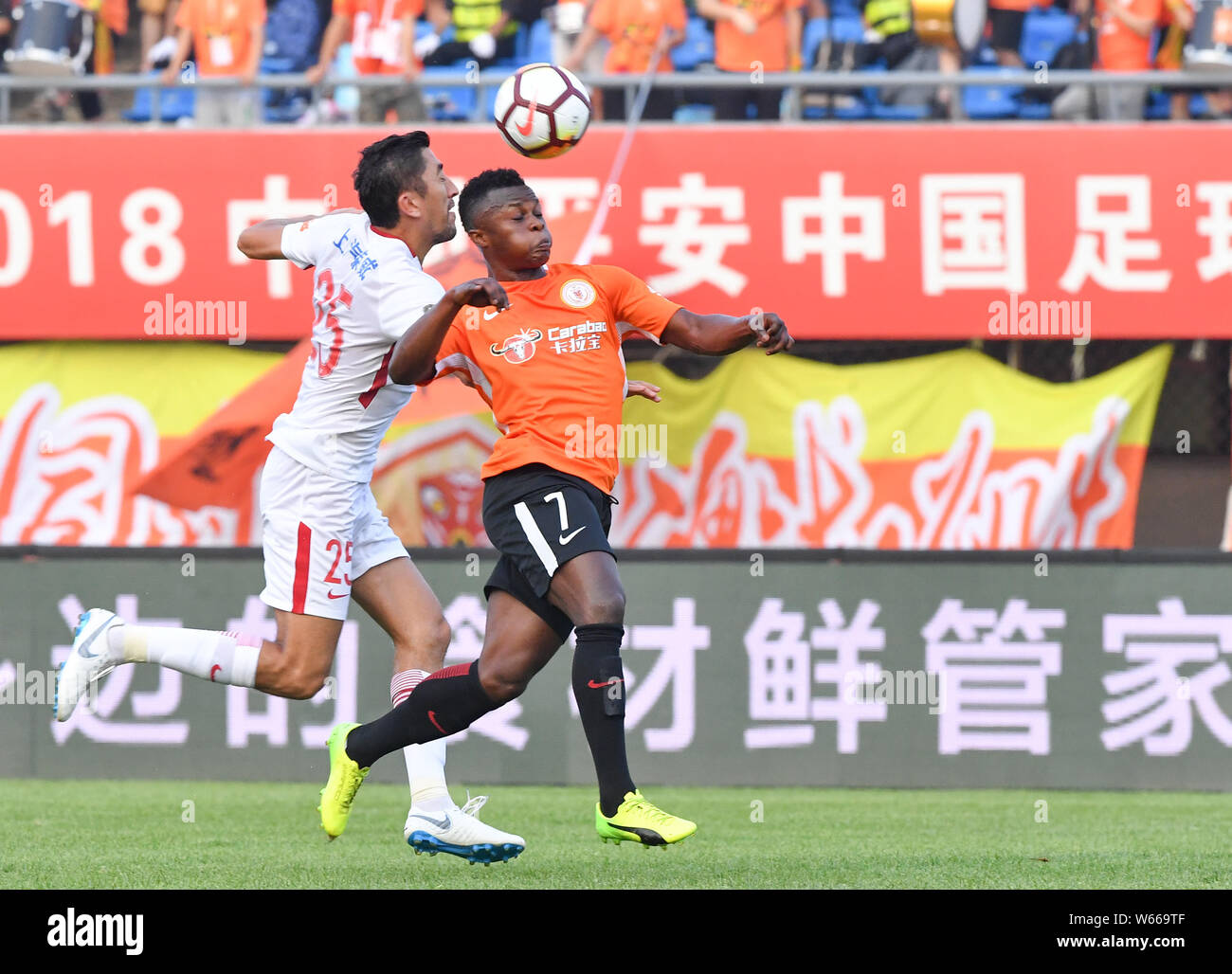 Uzbek football player Odil Ahmedov, left, of Shanghai SIPG challenges ...