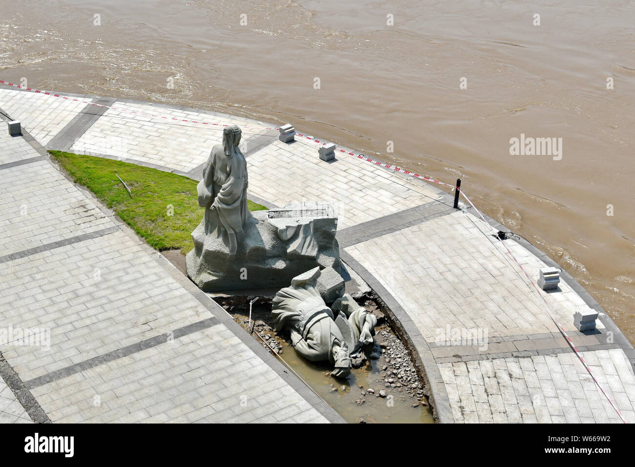 View of the standing statue of Huang Tingjian and the damaged statue of ...