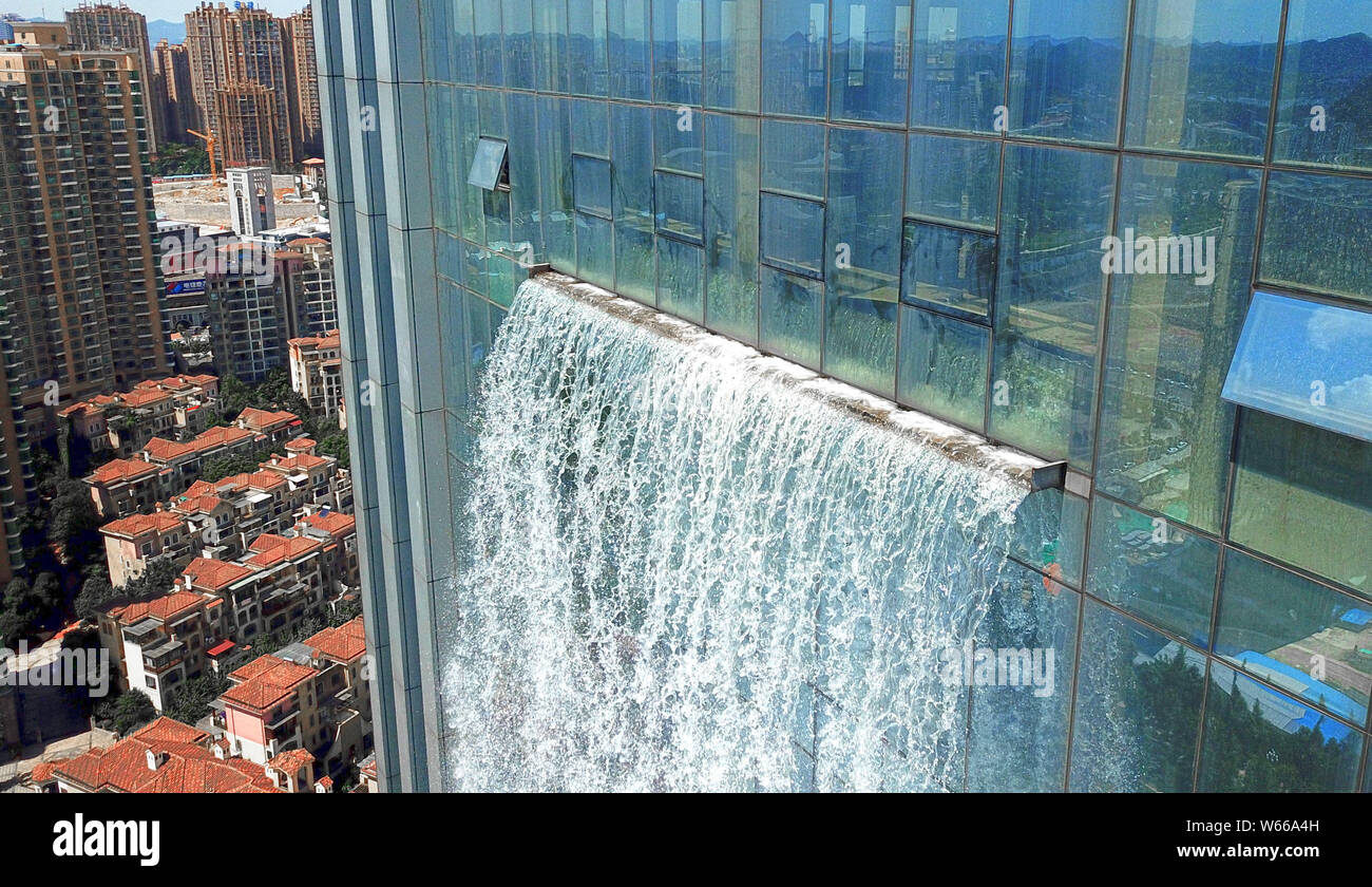 View of an artificial waterfall on the exterior of a 121-meter-tall ...