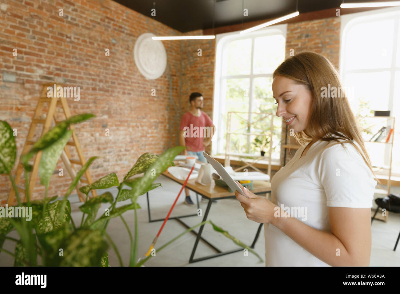 Young couple doing apartment repair together themselves. Married man ...