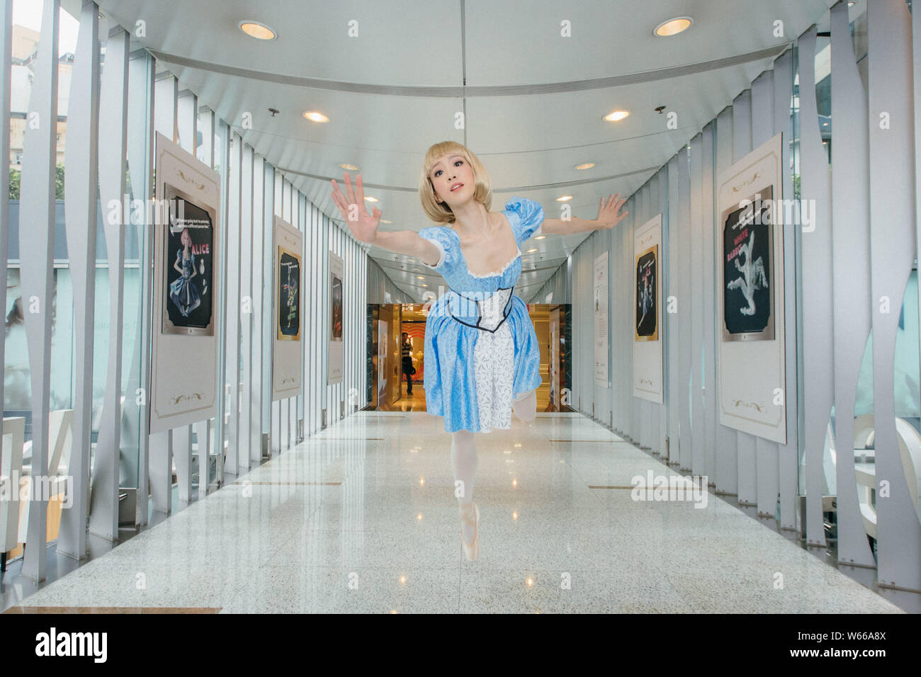 A ballet dancer poses at a city parade event for the Asia debut of ...