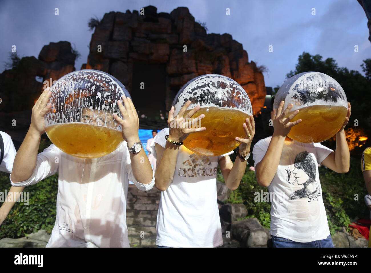 Participates use fish tanks to drink beer during a beer drinking ...