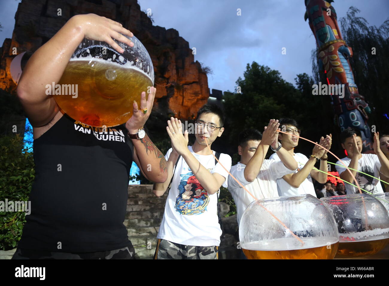 A participate uses a fish tank to drink beer during a beer drinking ...