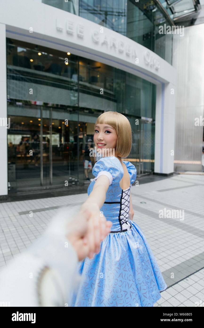 A ballet dancer poses at a city parade event for the Asia debut of ...
