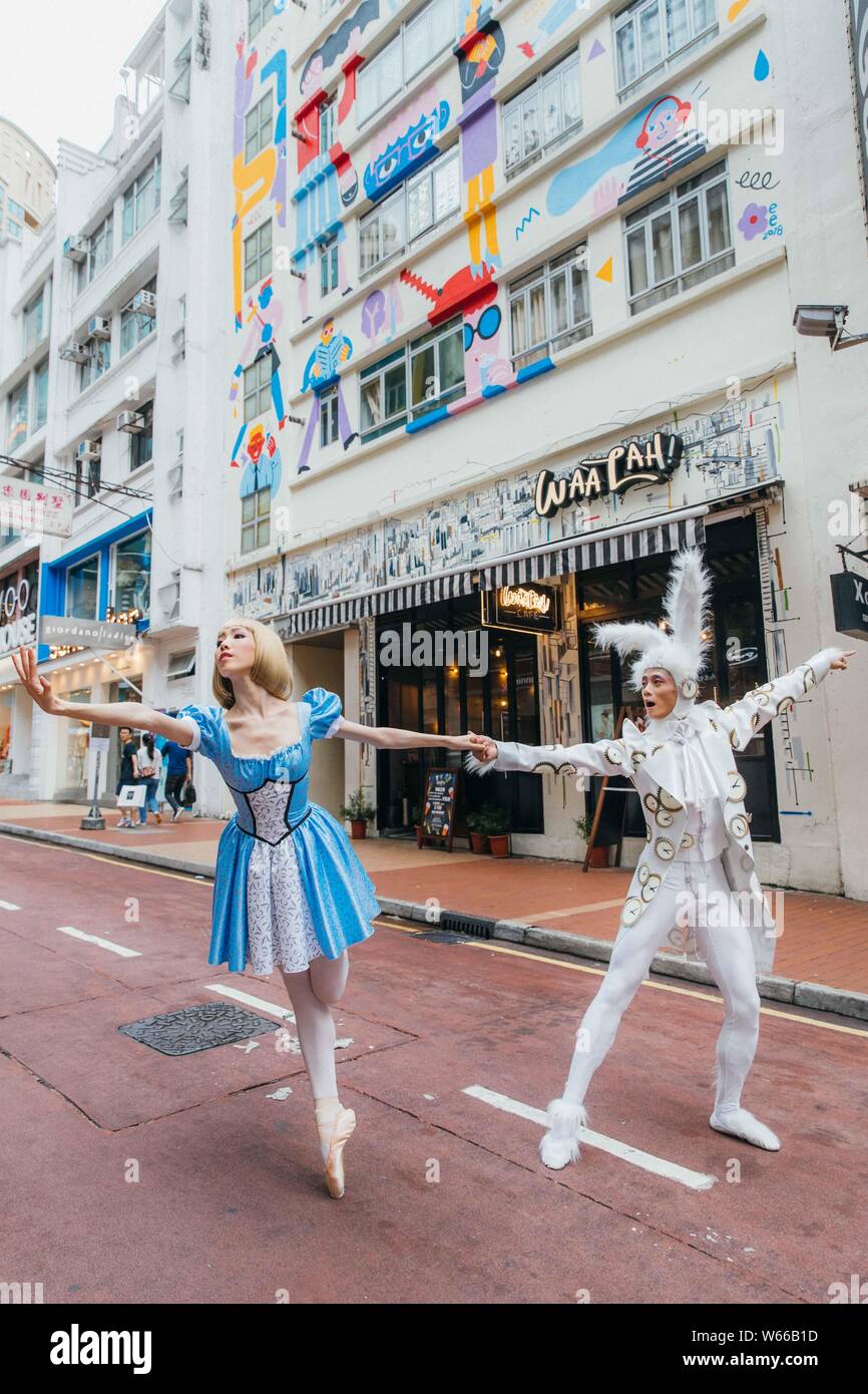 Ballet dancers pose at a city parade event for the Asia debut of "Alice ...