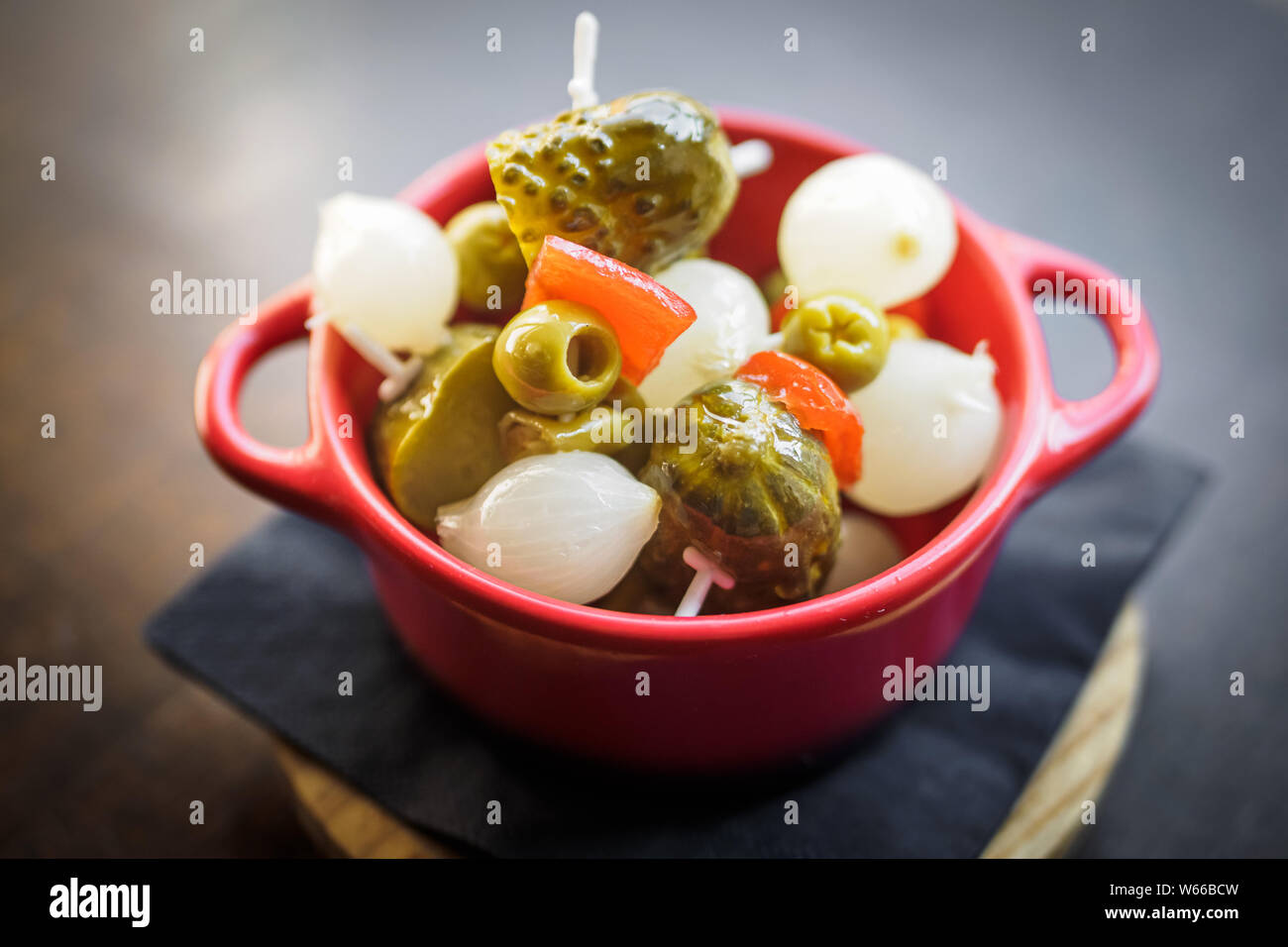 Spanish banderillas, skewers with pickling olives, garlic, pickles ...