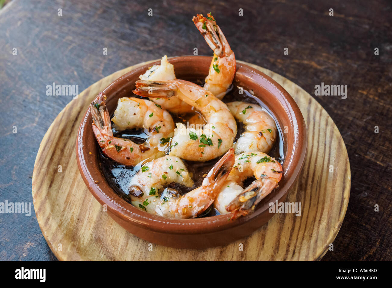 Garlic prawns, traditional Spanish tapas on and ceramic bowl Stock ...