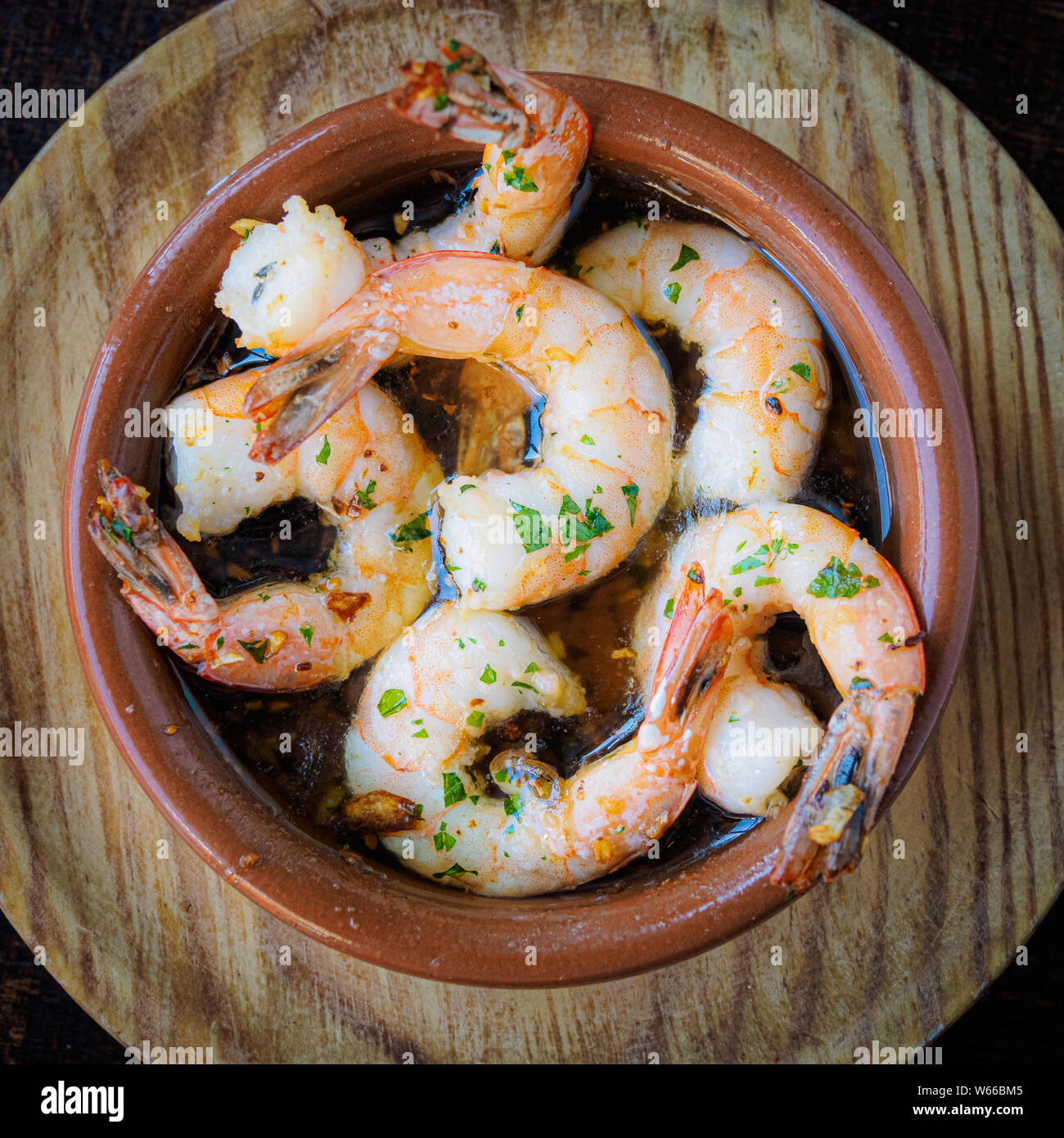 Garlic prawns, traditional Spanish tapas on and ceramic bowl Stock ...