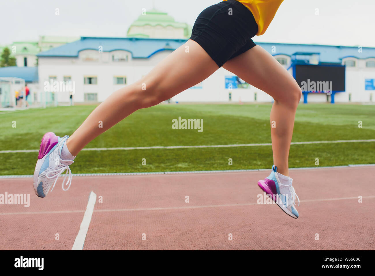 Cropped shot of young female athlete launching off the start line in a ...