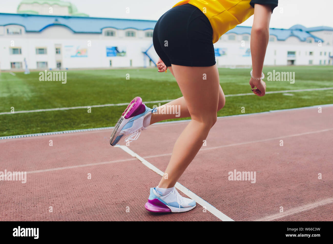 Cropped shot of young female athlete launching off the start line in a ...
